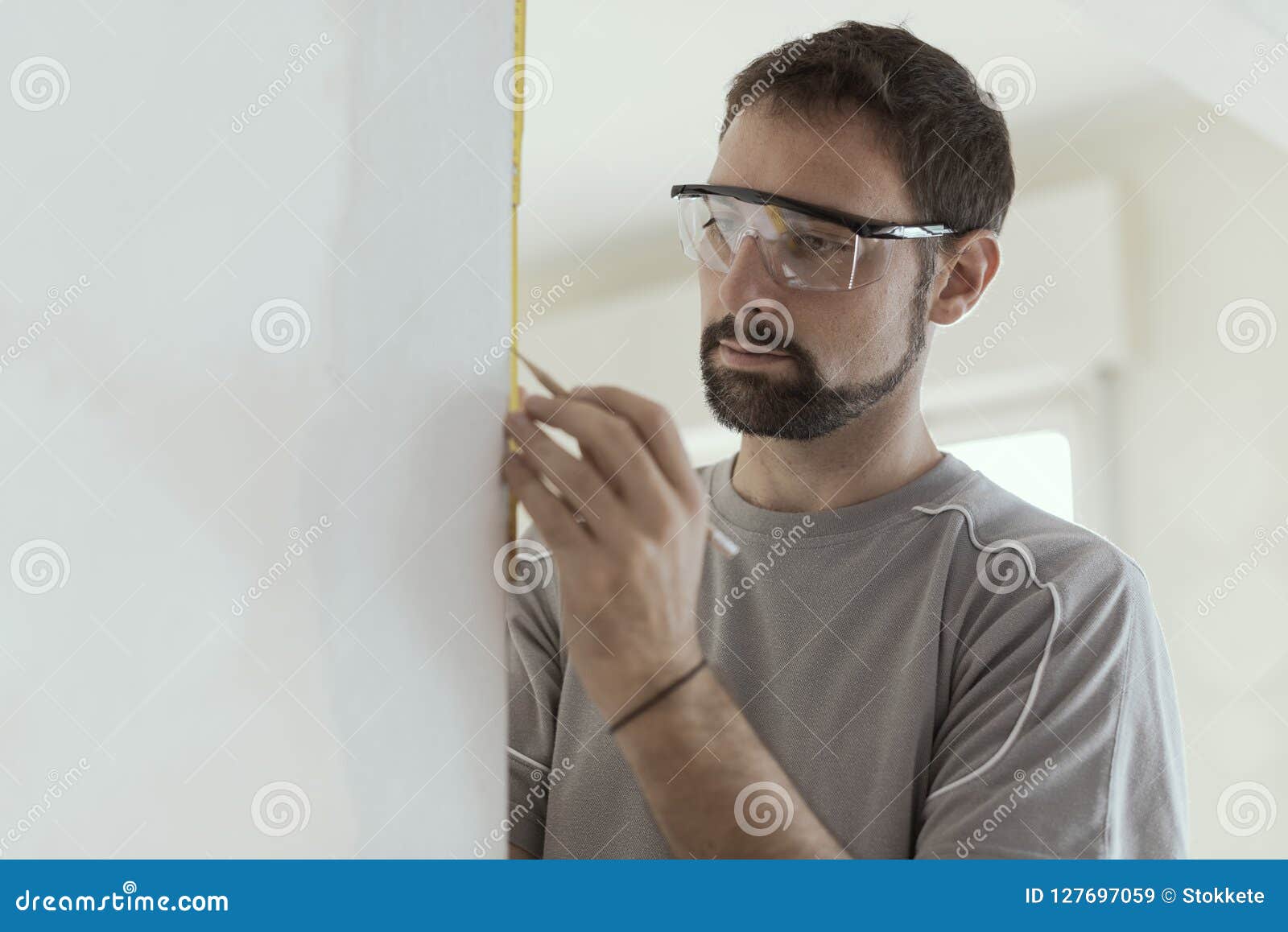Man Measuring a Wall Using a Folding Ruler Stock Image - Image of ...