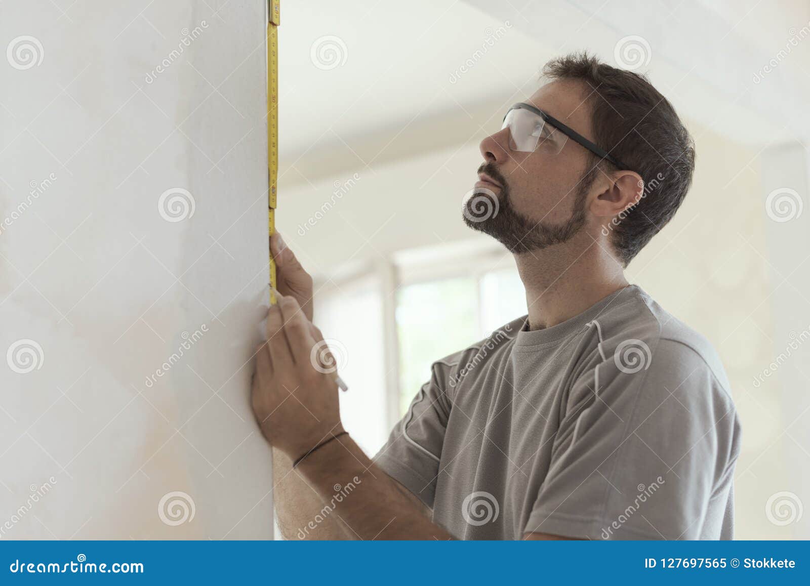 Man Measuring a Wall Using a Folding Ruler Stock Image - Image of home ...