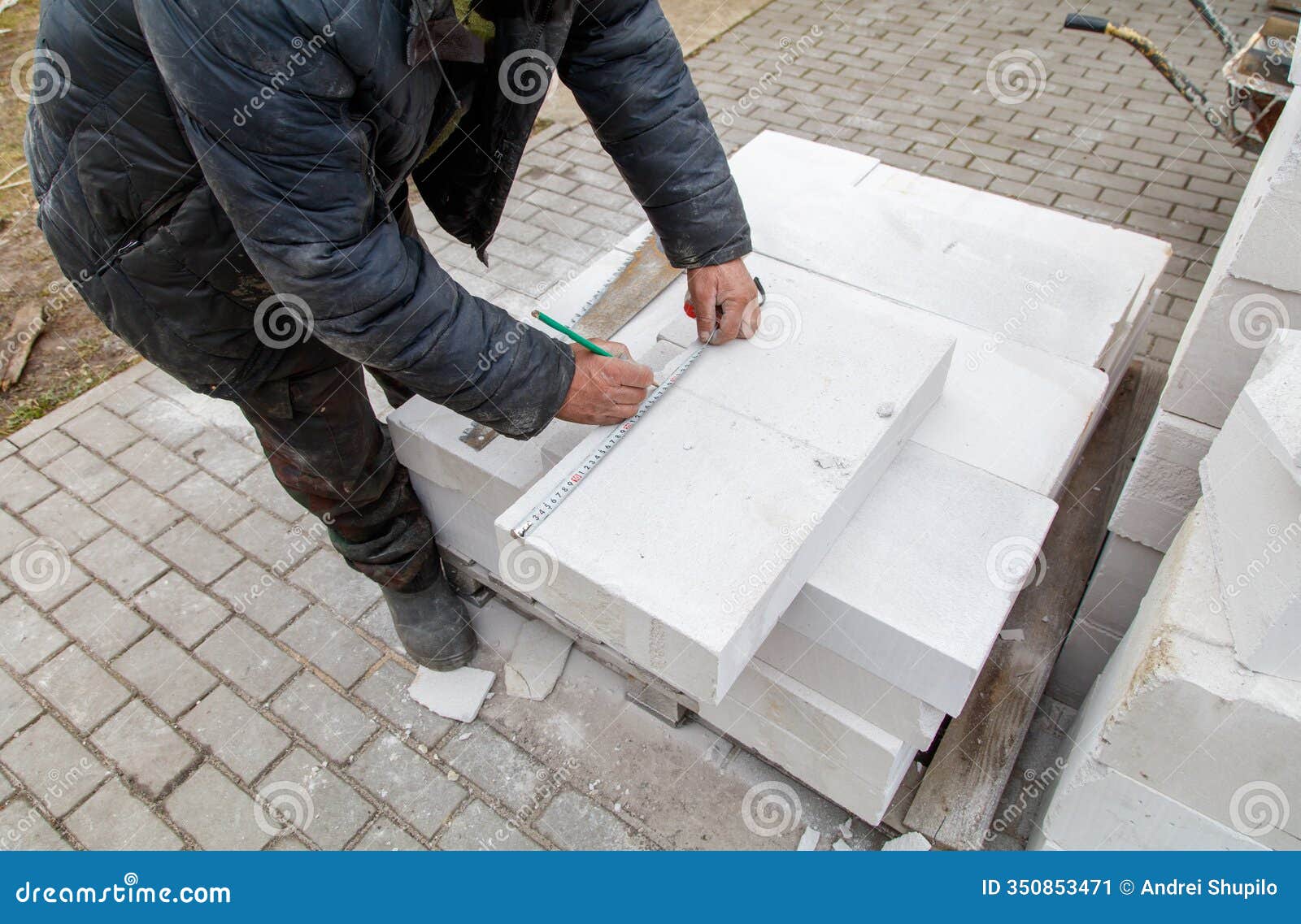 A Man is Measuring a White Block with a Ruler Stock Image - Image of ...