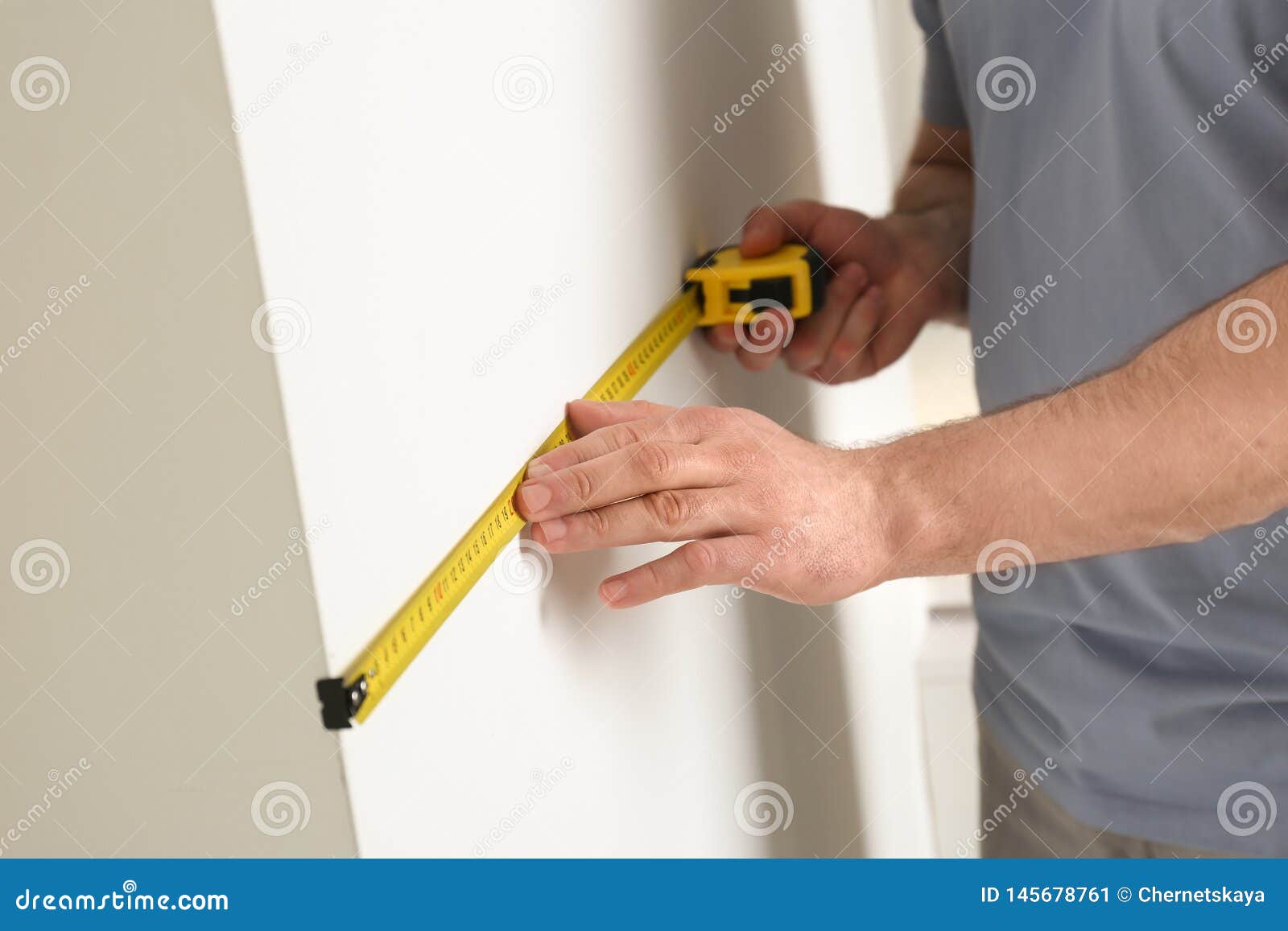 Man Measuring White Wall Indoors. Construction Tool Stock Image - Image ...