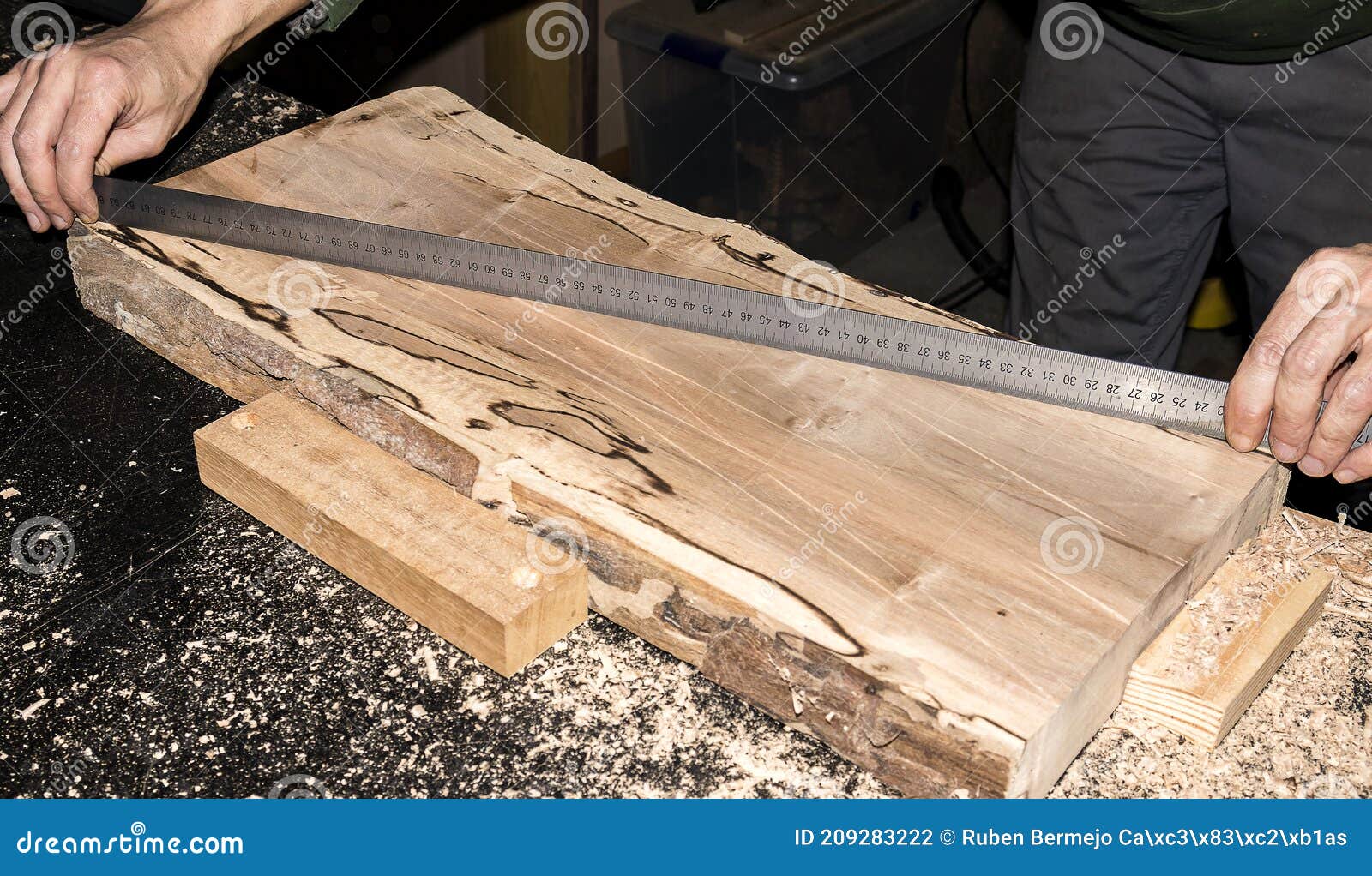 Man Carpenter Measuring Wooden Plank with Ruler on Carpentry Table ...