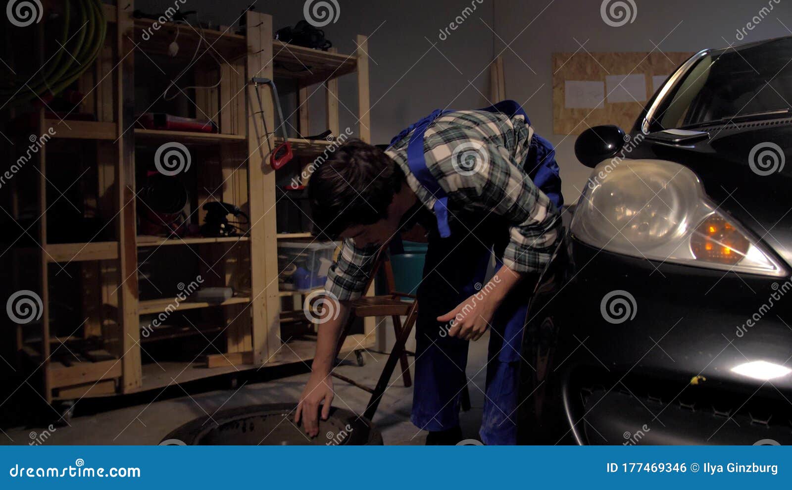 Man Mechanic Putting on Uniform in Garage Stock Photo - Image of ...