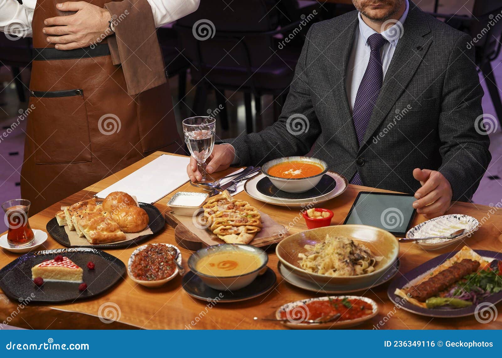 Man with Menu in a Restaurant Taking Order at Table Stock Photo - Image ...