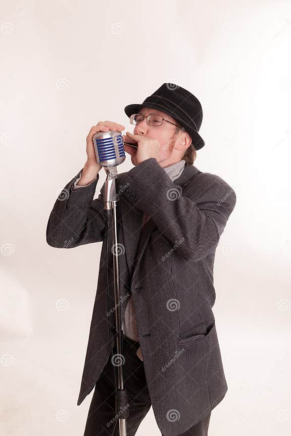 Man with a Microphone Playing the Harmonica Stock Image - Image of ...