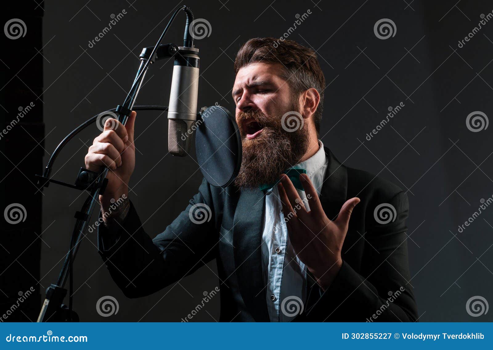 Man with Microphone Singing in Music Hall. Stock Image - Image of ...