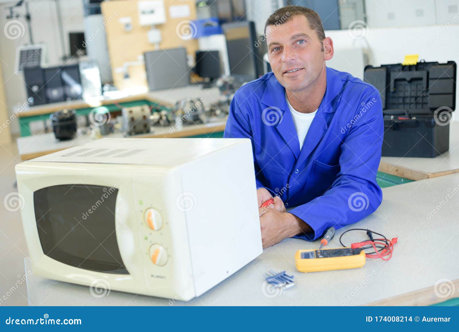 Man with microwave stock photo. Image of appliance, overalls - 174008214