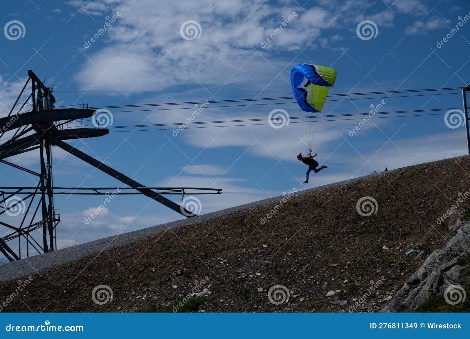 Man in Mid-air, Gliding Gently through the Sky, with a Parachute Stock ...