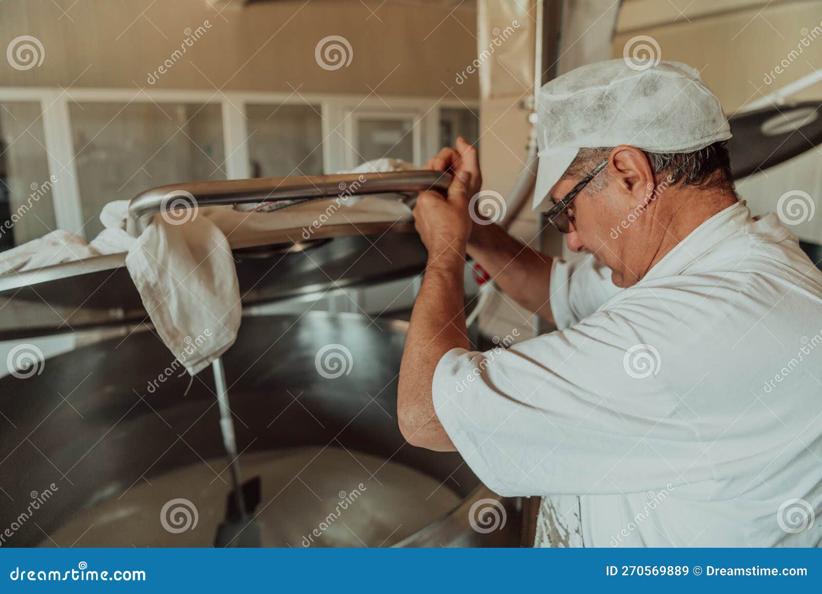 Man Mixing Milk in the Stainless Tank during the Fermentation Process ...