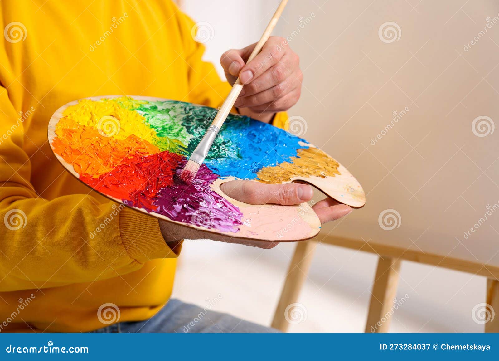 Man Mixing Paints on Palette with Brush in Studio, Closeup. Using Easel ...