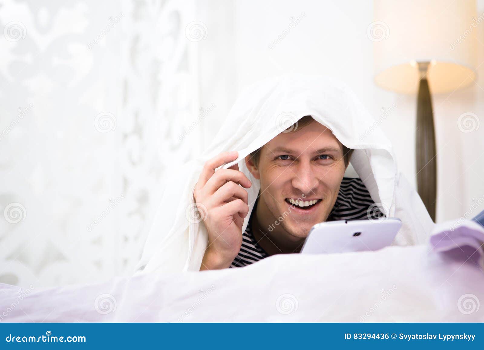 Man with Mobile Phone in Bed Stock Photo - Image of horizontal, lying ...