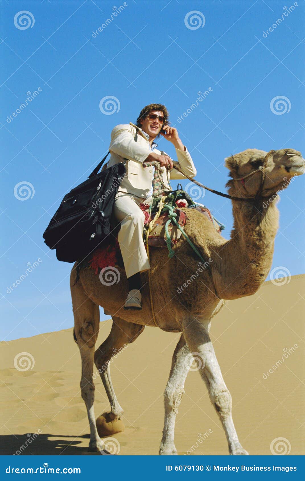 A Man Riding On A Camel On An Empty Beach Royalty-Free Stock ...