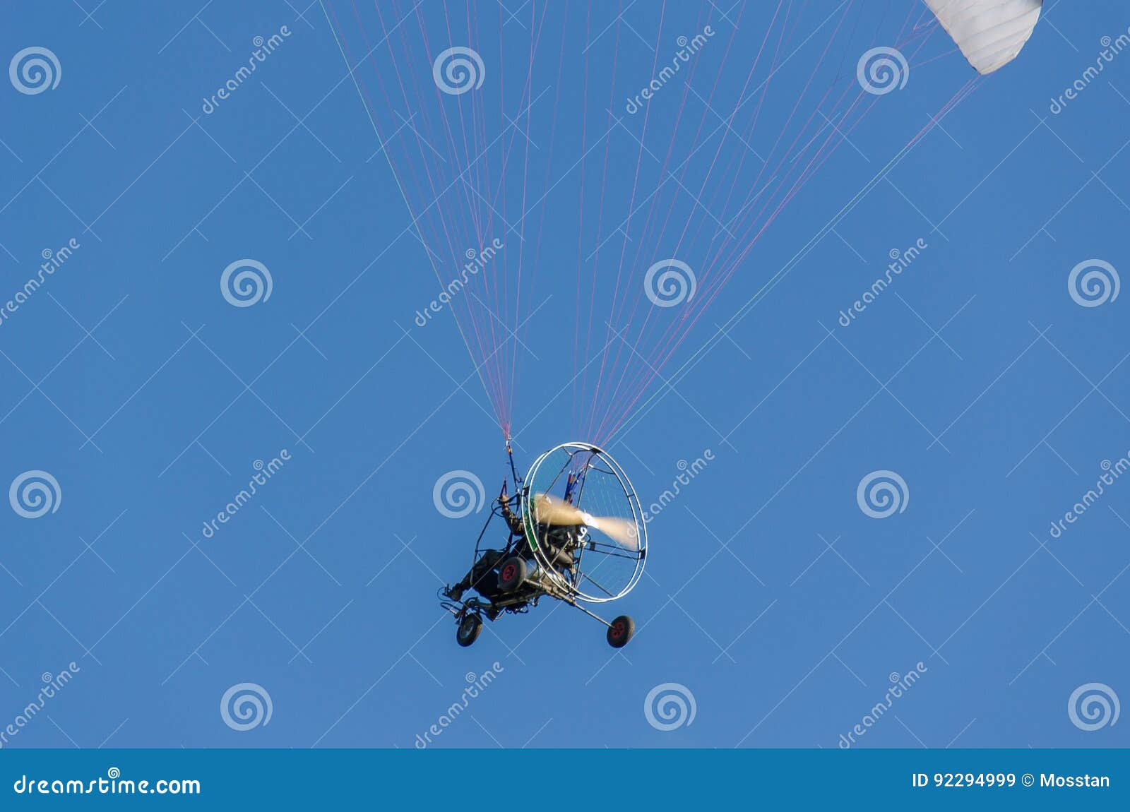 A Man on a Motor Paraplan in a Blue Sky Stock Image - Image of extreme ...