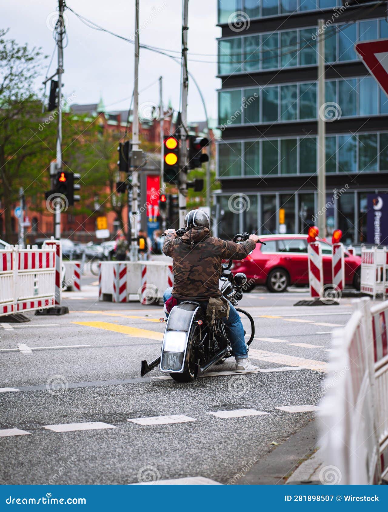 Man on a Motorcycle Navigating through a Busy City Street with Traffic ... Man on a Motorcycle Navigating through a Busy City Street with Traffic ...