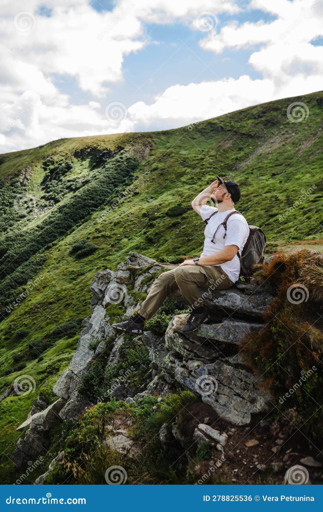 Man in the Mountains Sitting on a Rock Stock Photo - Image of person ...