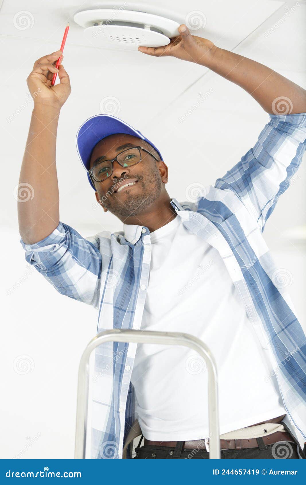Man mounting ceiling lamp stock image. Image of power - 244657419