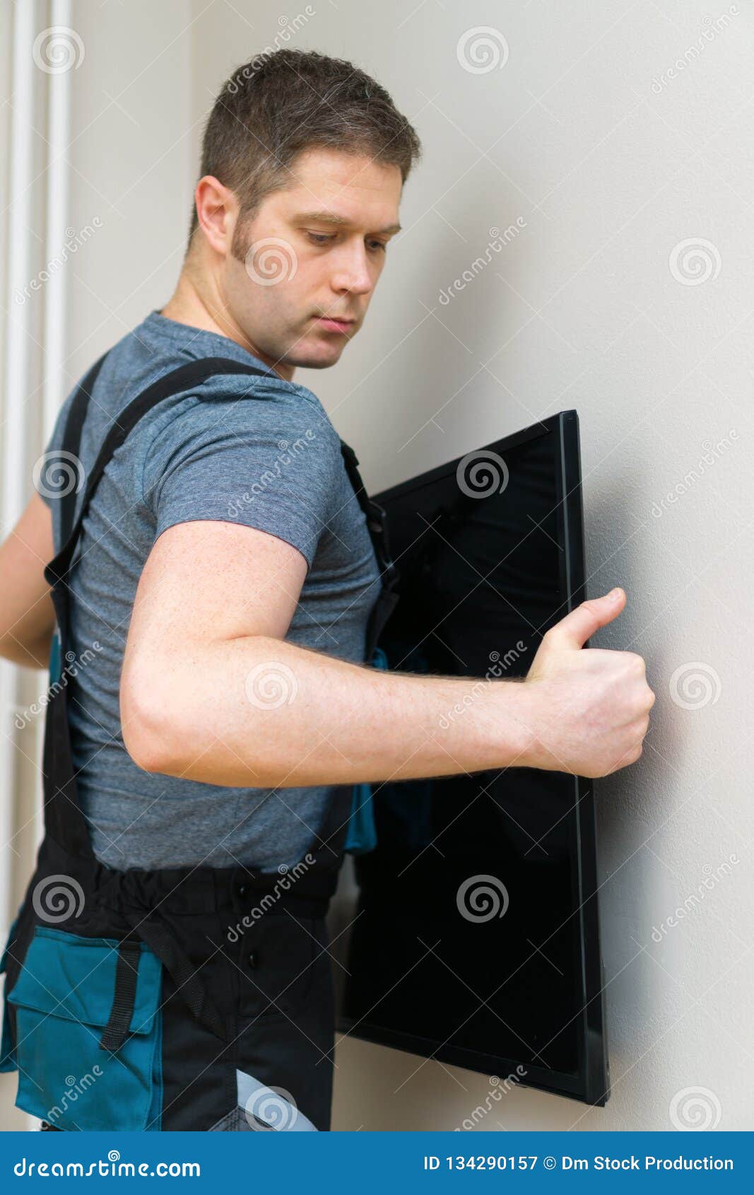 Man mounting TV stock image. Image of room, condominium - 134290157