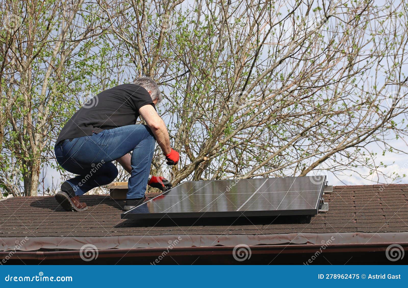 A Man Mounting a Small Solar System on a Garden Shed Stock Image ...