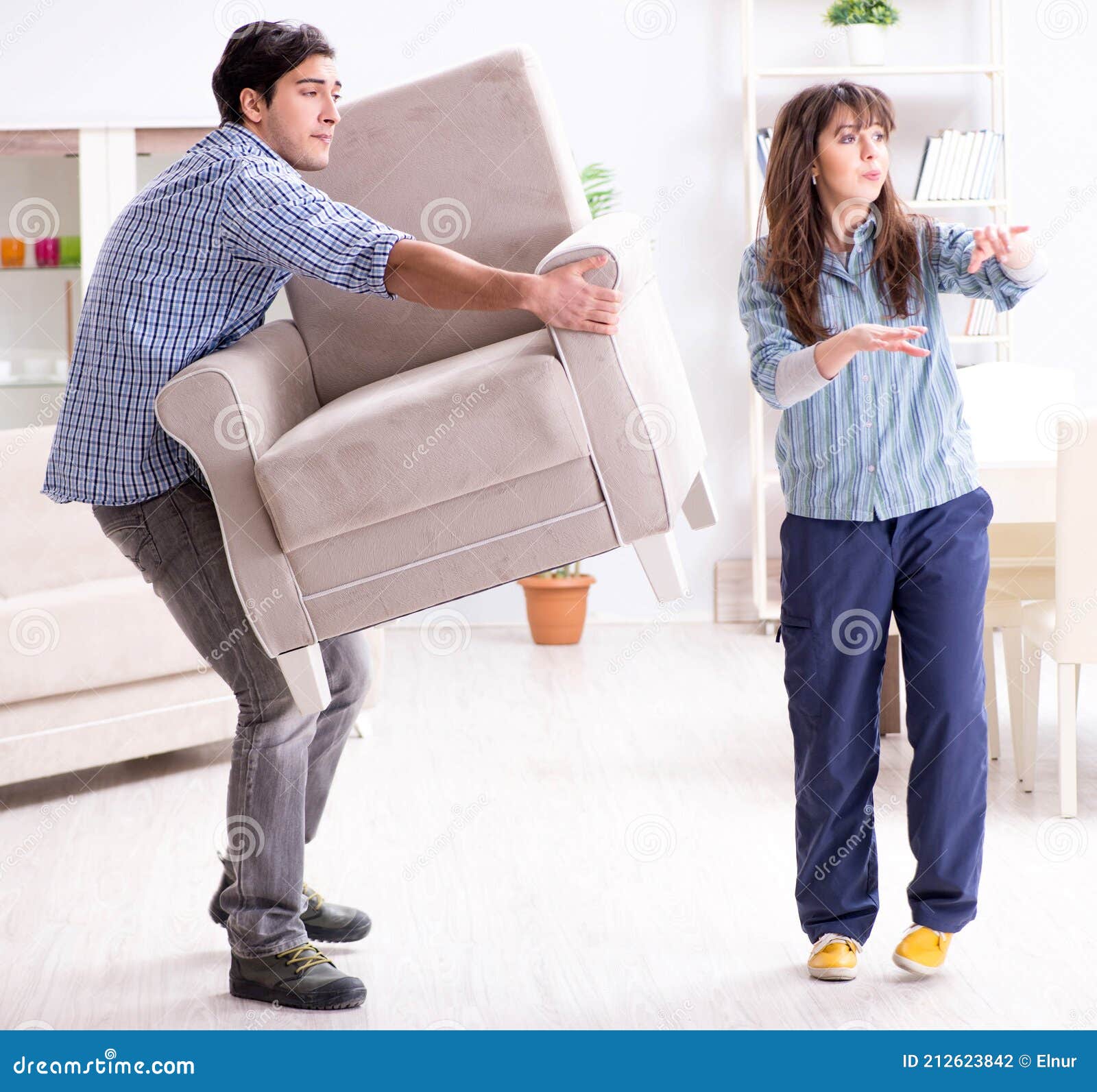 Man Moving Armchair in the Living Room Stock Photo - Image of chair ...