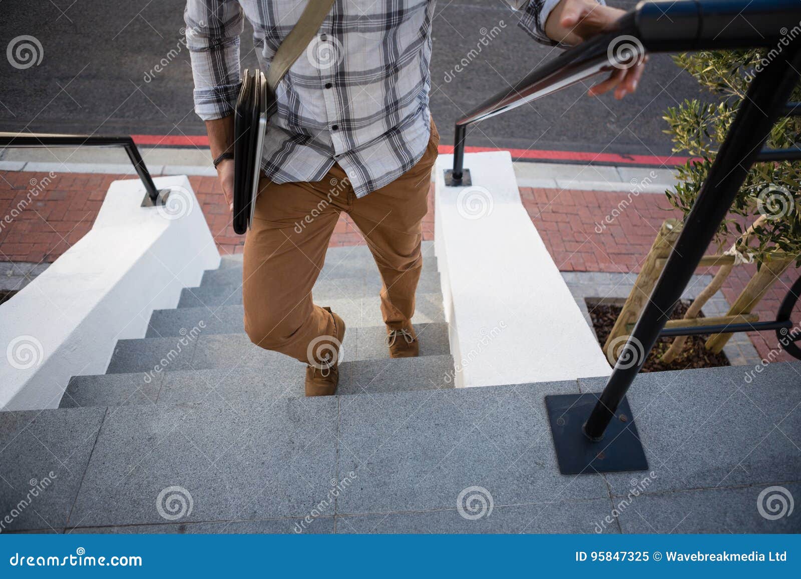Man moving up on steps stock image. Image of holding - 95847325