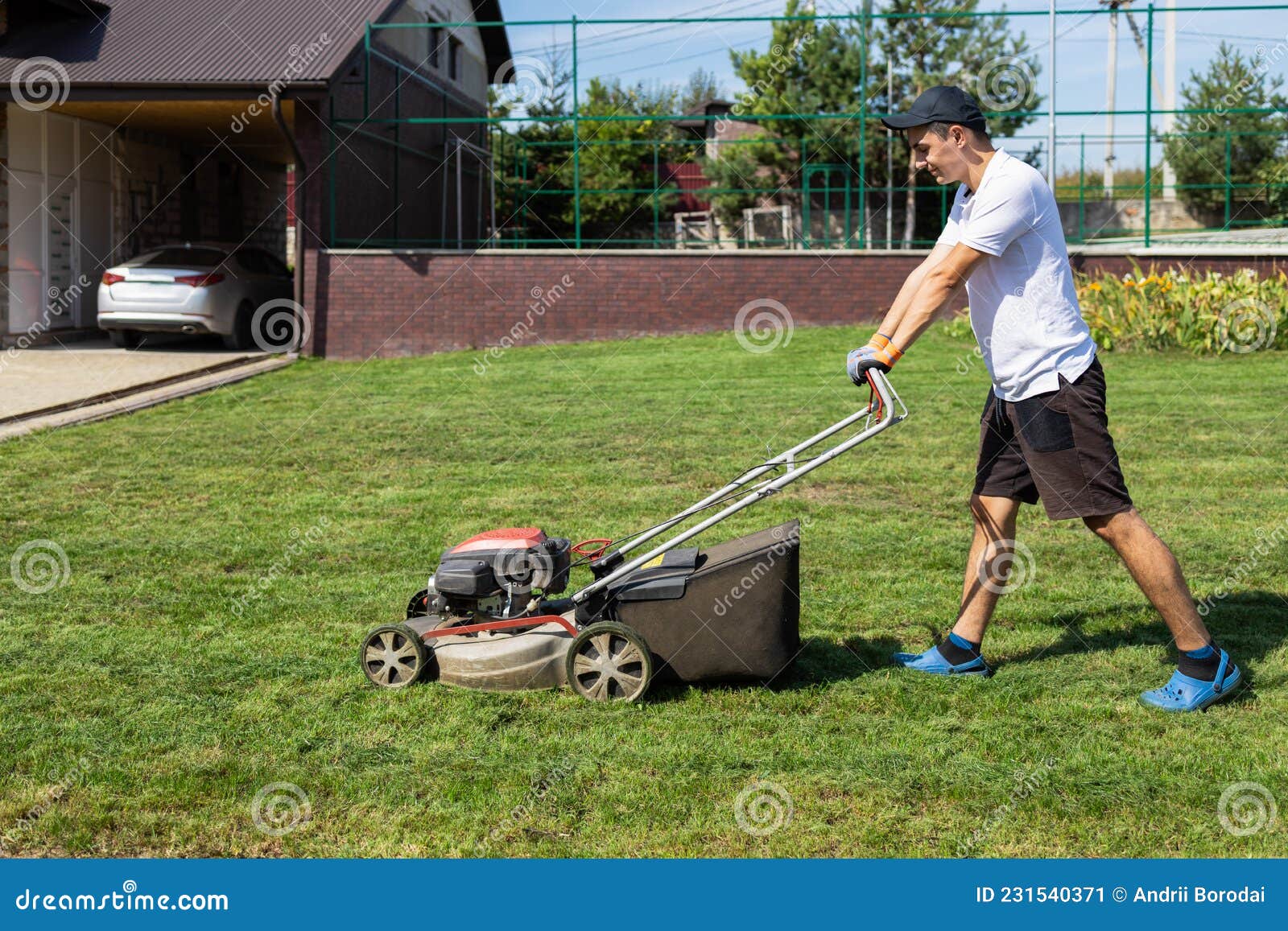 Man Mowing the Lawn in the Backyard. Stock Image - Image of person ...