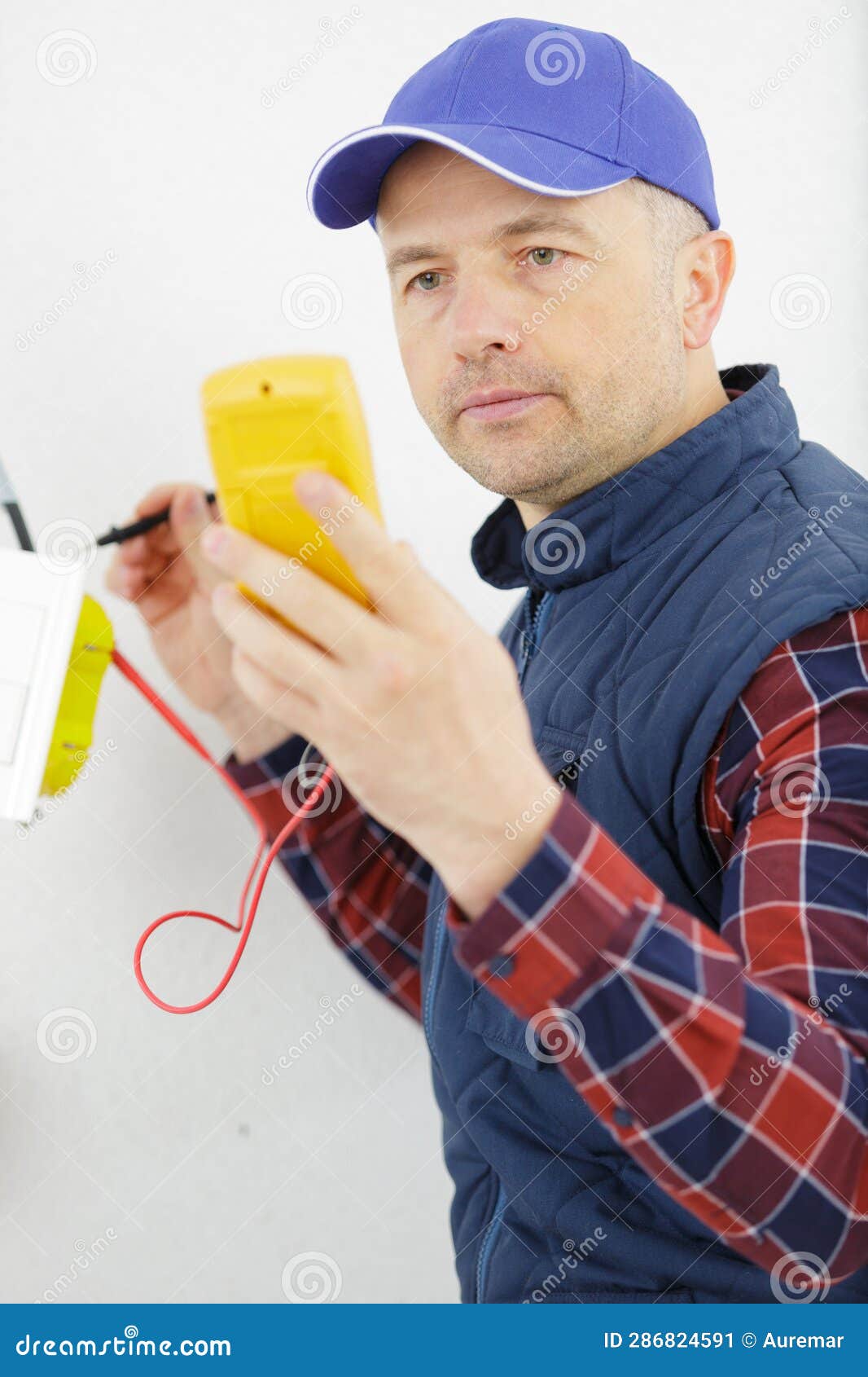 Man with Multimeter Checking Voltage in Wall Fixture Stock Image ...