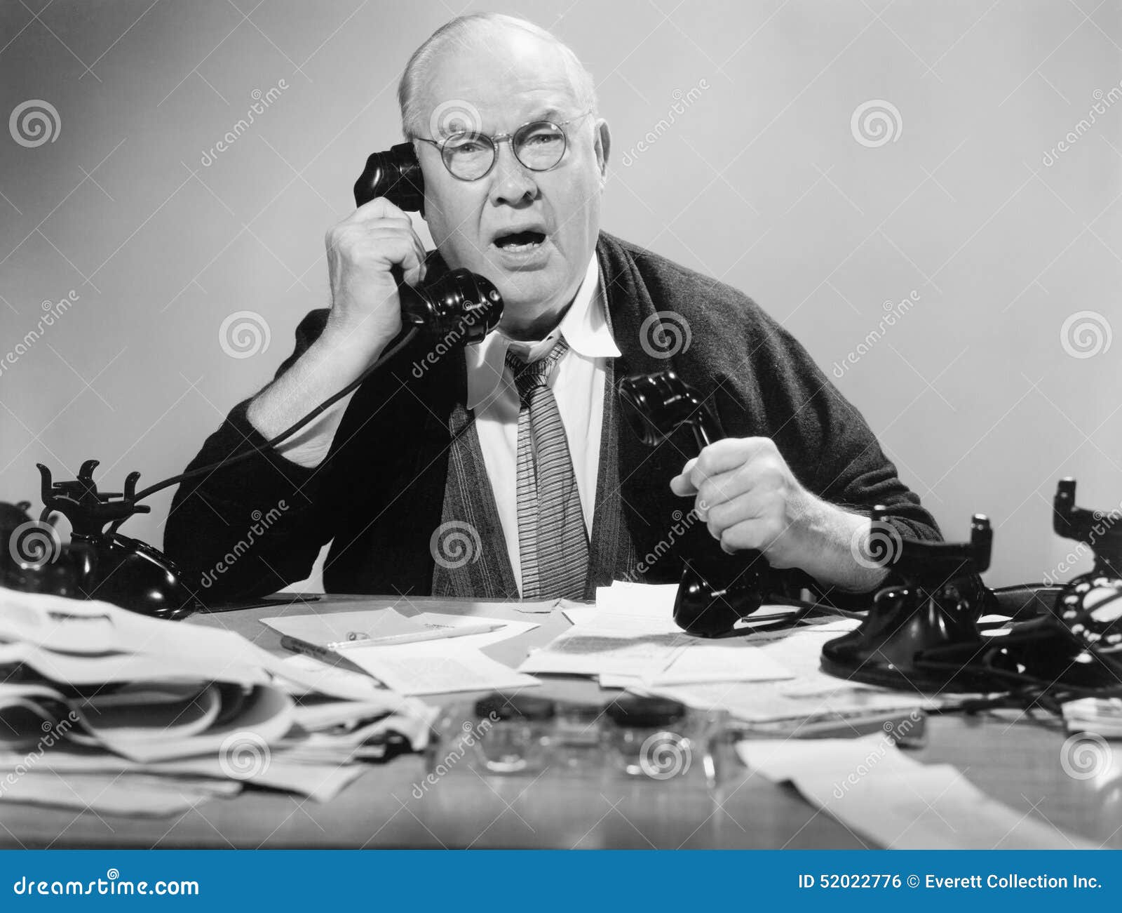 Man on Multiple Telephones Looking Angry Stock Photo - Image of fist ...