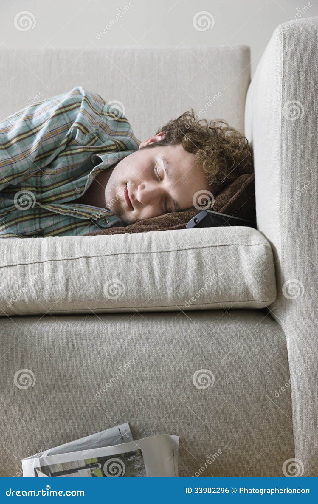 Man Napping on Sofa stock photo. Image of control, people - 33902296
