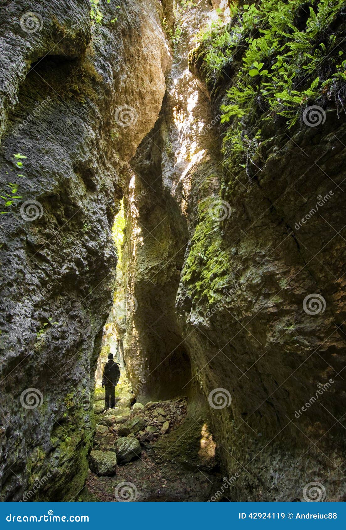 Man in Narrow Valley with Huge Rocks and Cave Stock Image - Image of ...