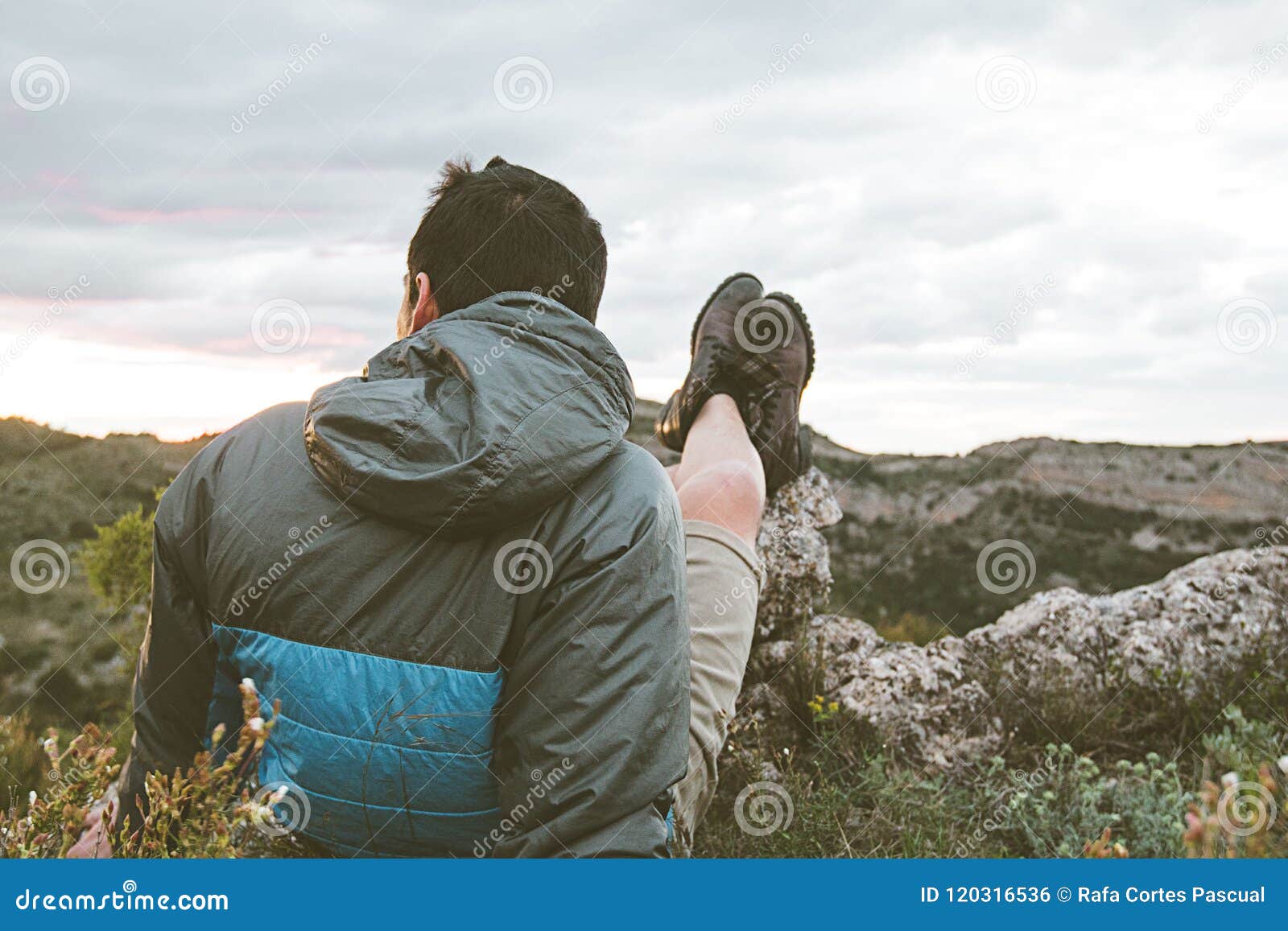 Man in Nature Relaxed and Seated. Guy Observing the Landscape in the ...