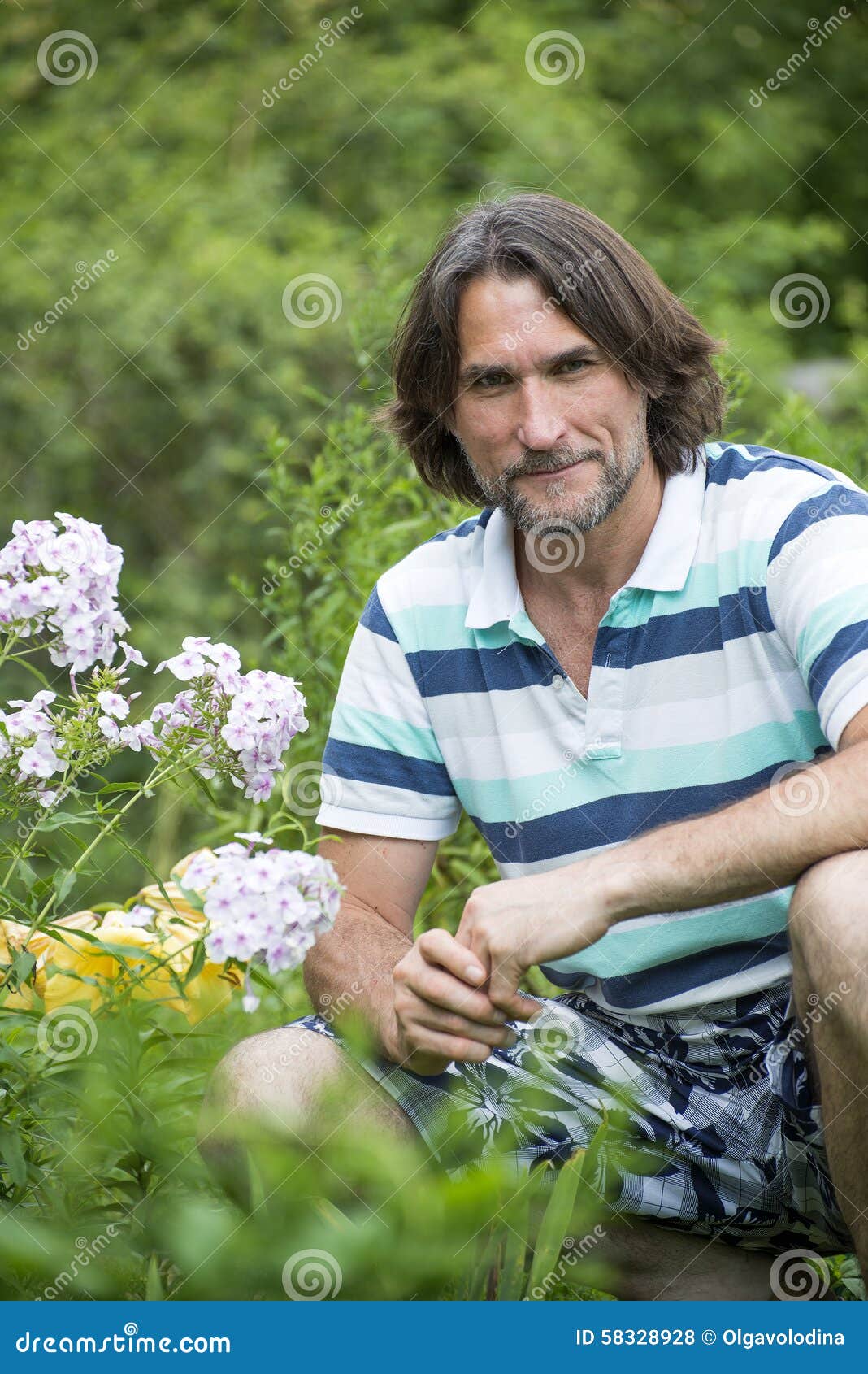A Man Near the Flowerbeds in the Garden Stock Photo - Image of flower ...