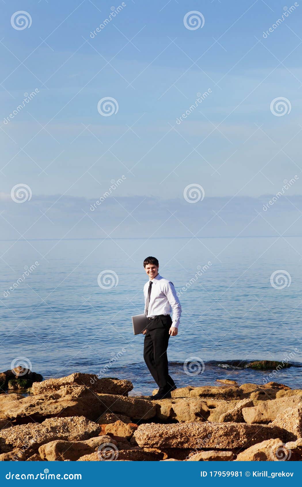Man near sea with laptop stock image. Image of stones - 17959981