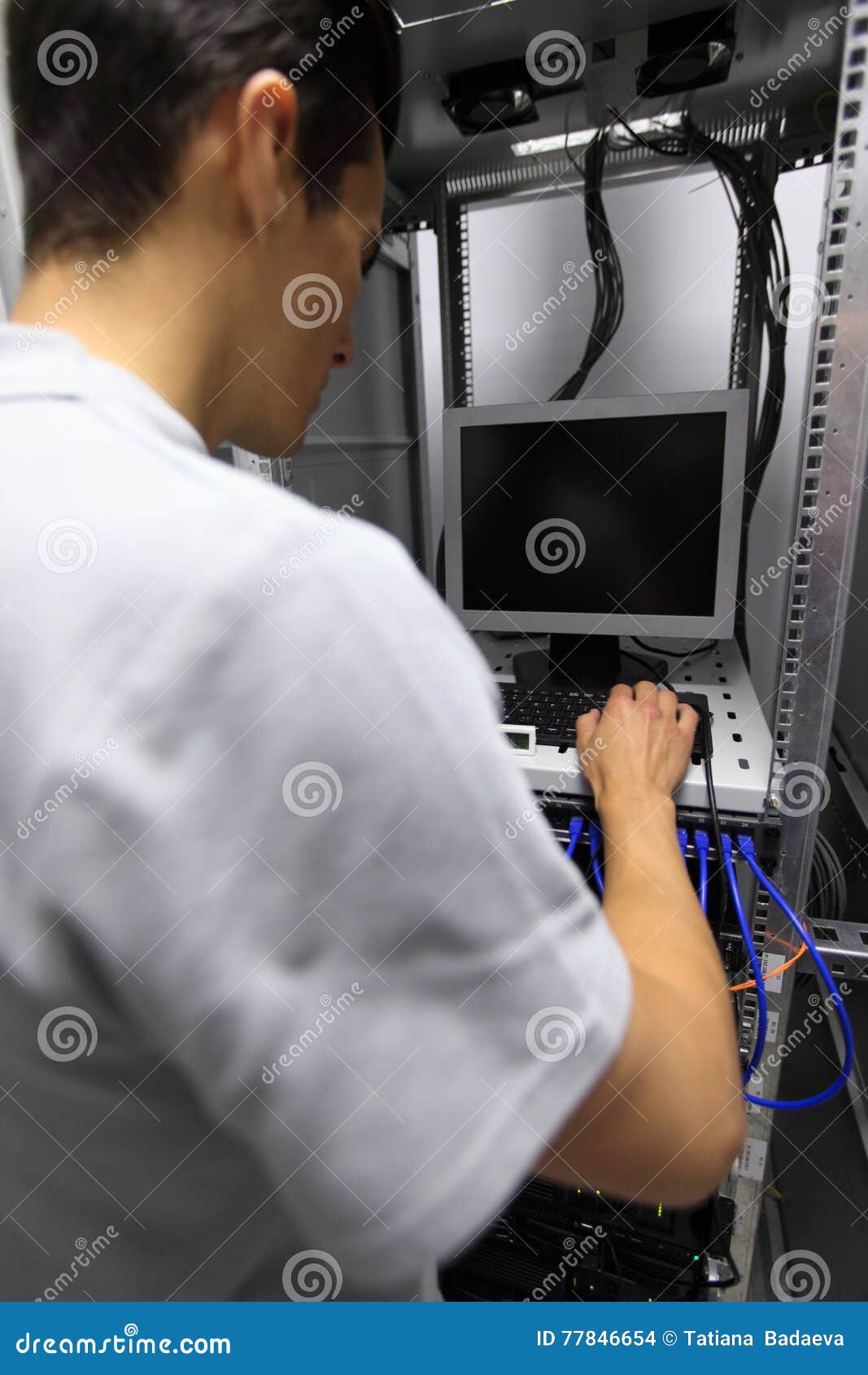 Man in network server room stock photo. Image of datacenter - 77846654