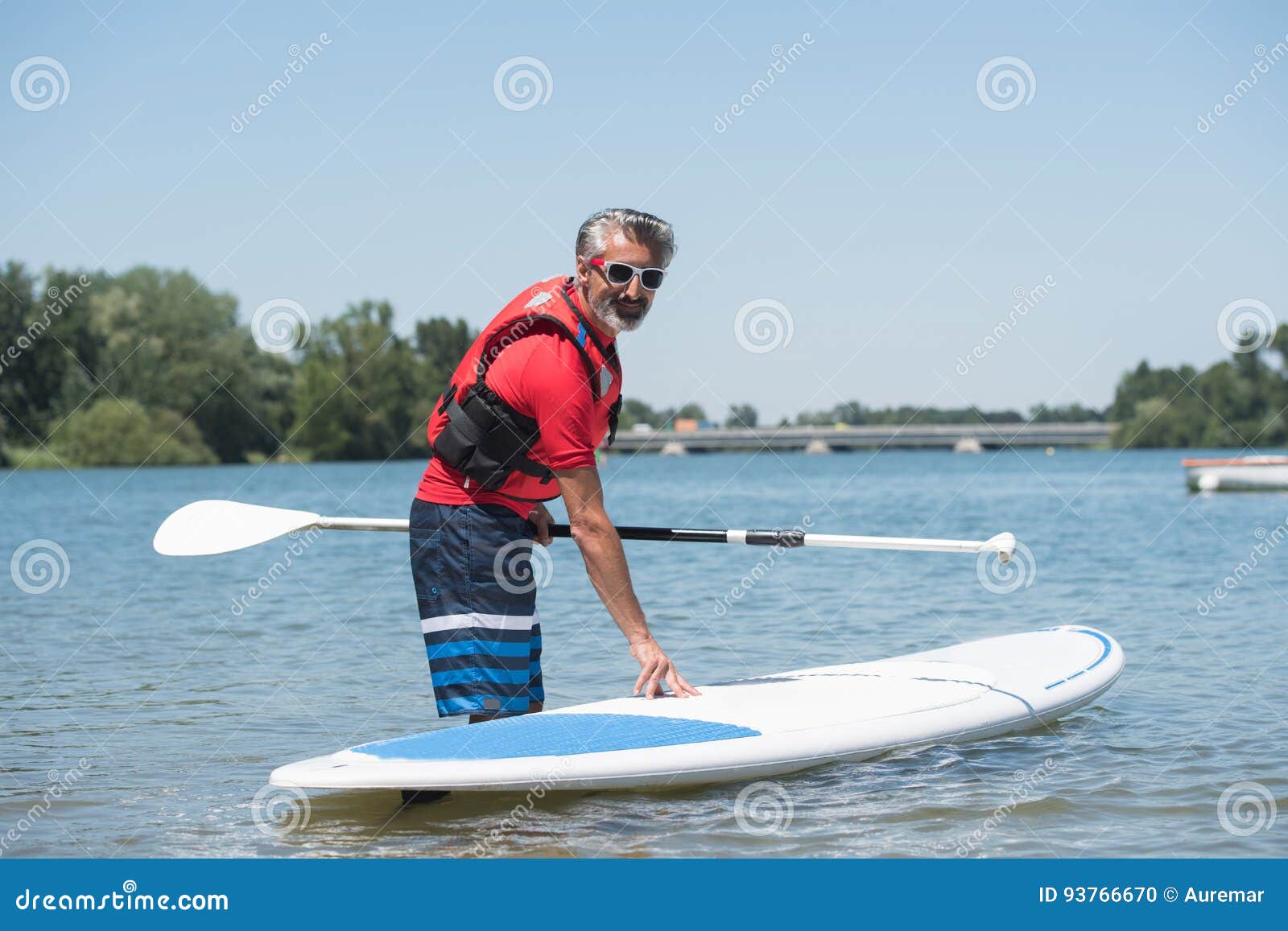 Man Next To Stand-up Paddle Board on Lake Stock Photo - Image of ...