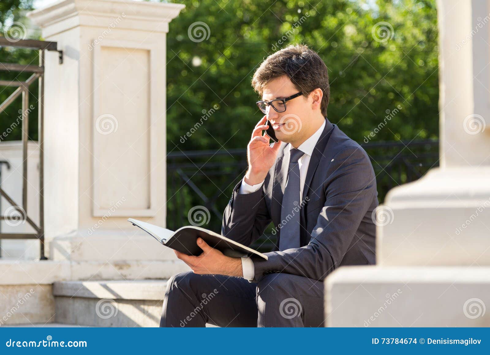 Man with notepad on phone stock photo. Image of calling - 73784674