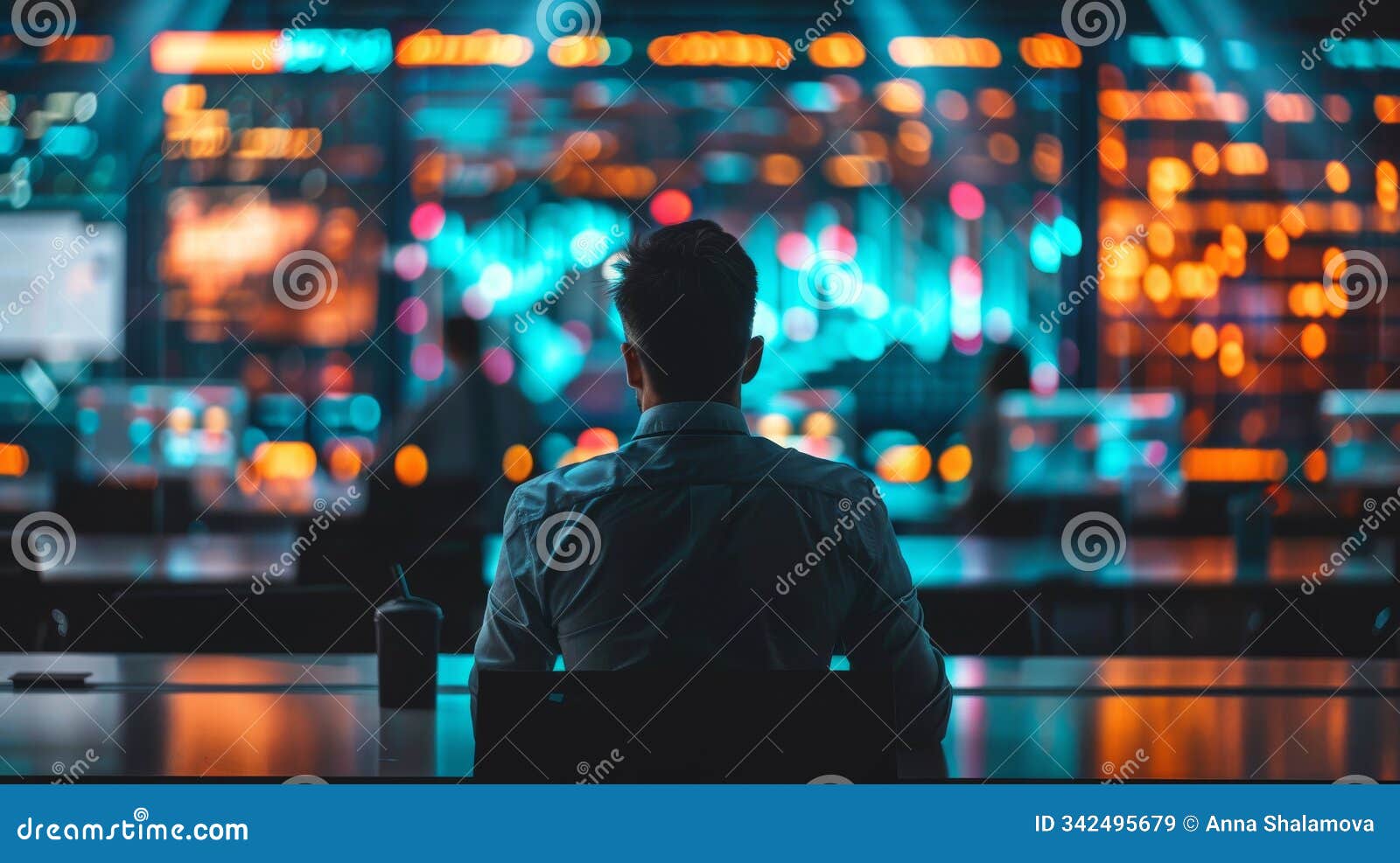 Man Observing Vibrant Digital Screen with Data Visualizations in Modern ...