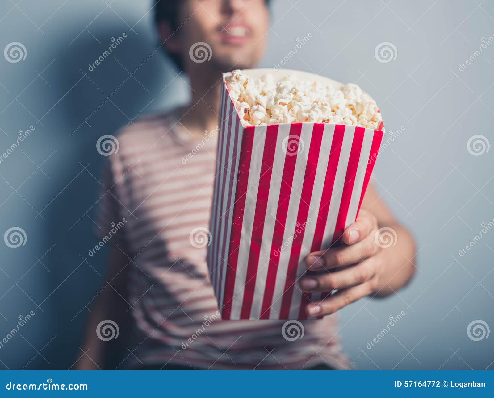 Man offering popcorn stock photo. Image of leisure, casual - 57164772