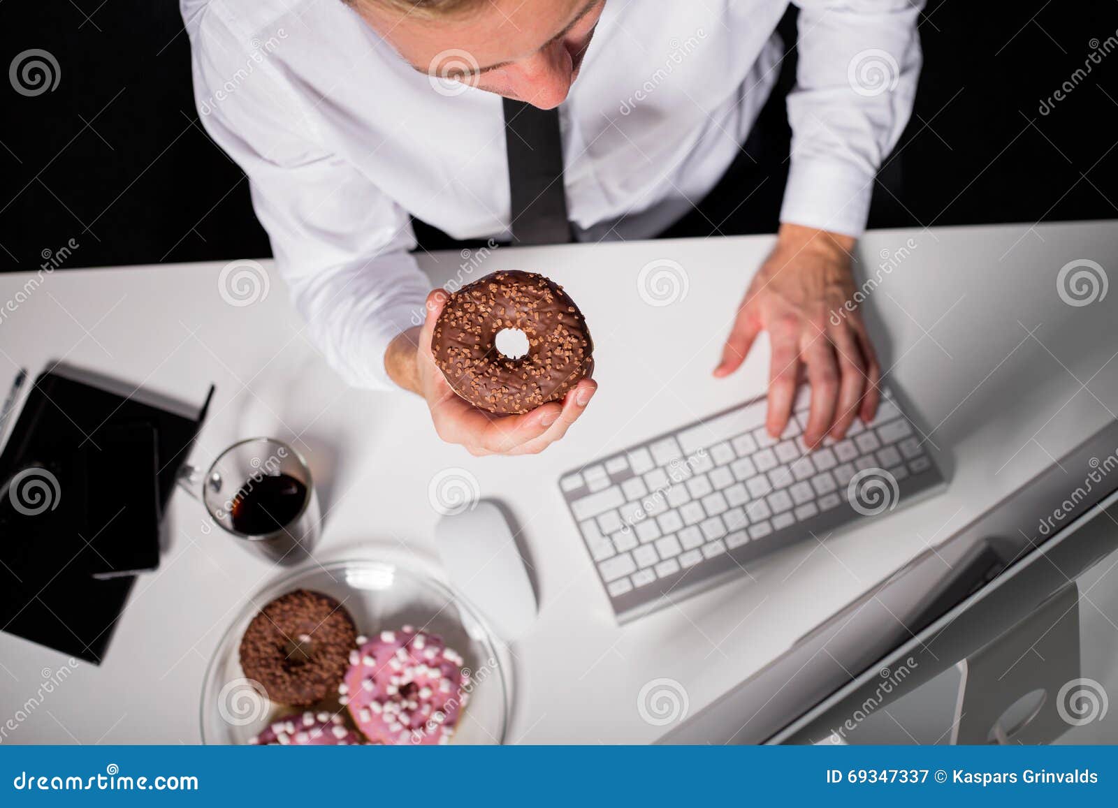 Man at the Office Eating Donuts Stock Image - Image of gadgets, tasty ...