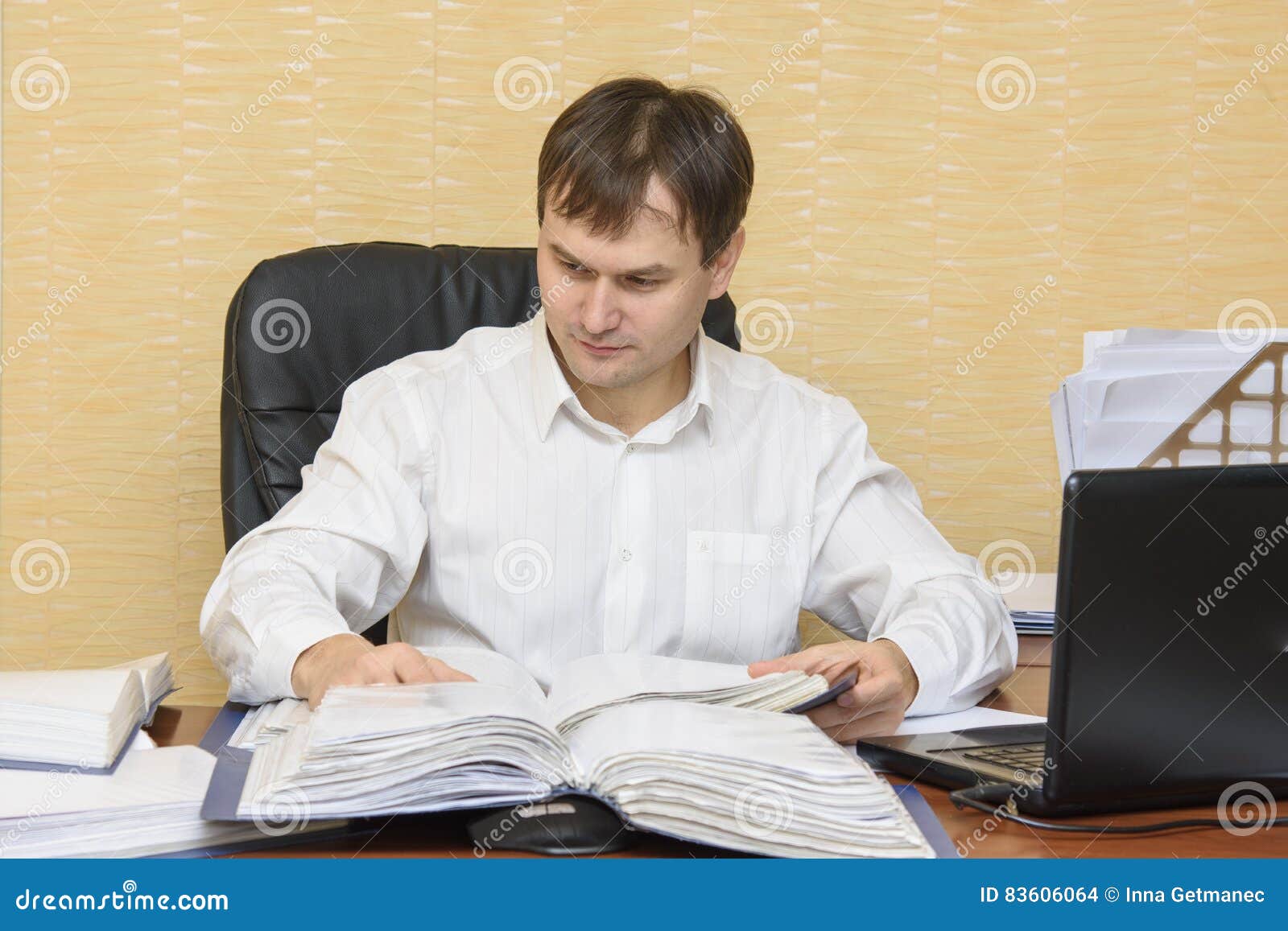 The Man in the Office Looking at Documents in Folders Stock Photo ...