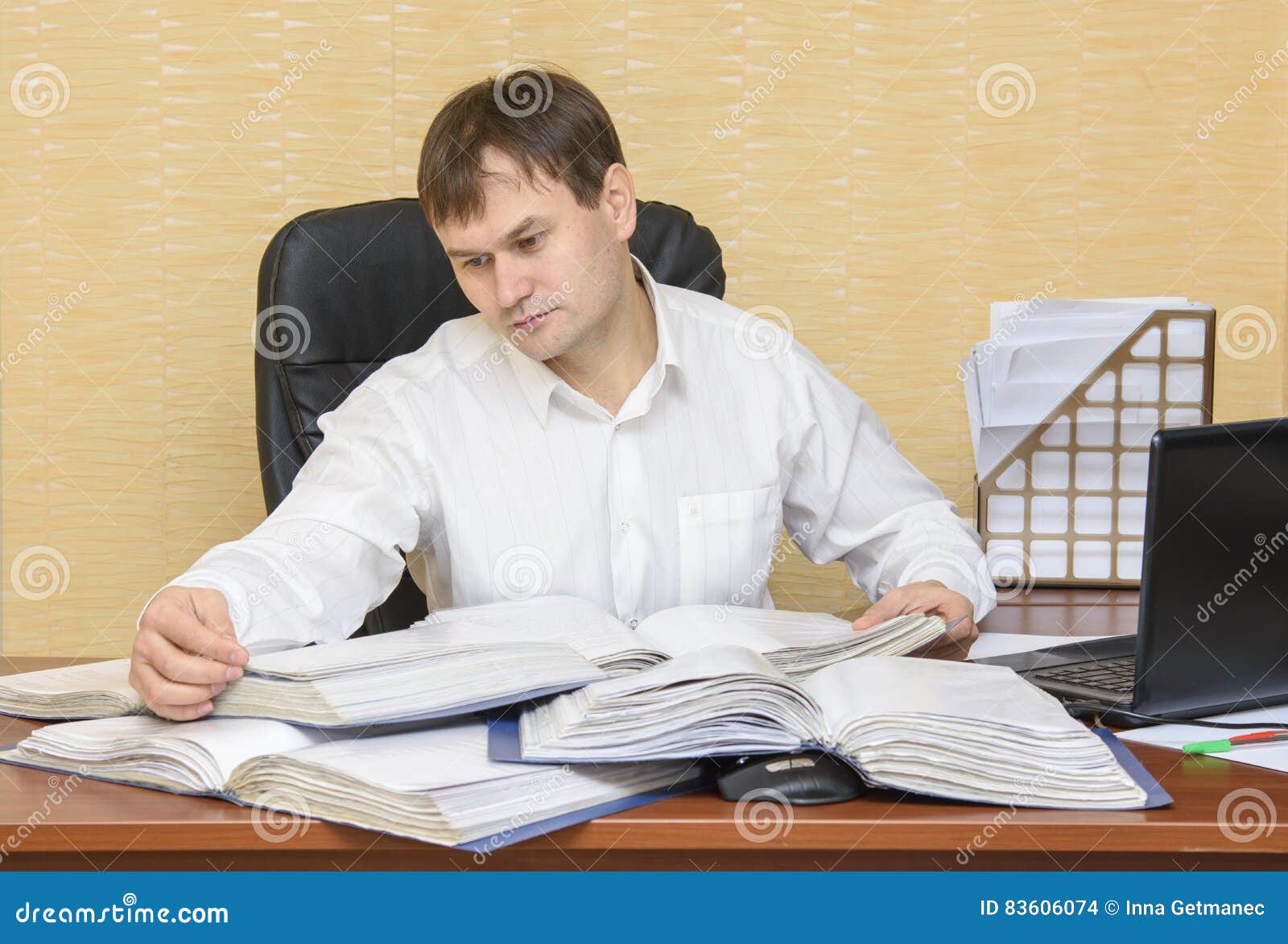 The Man in the Office Looking at Documents in Folders Stock Photo ...