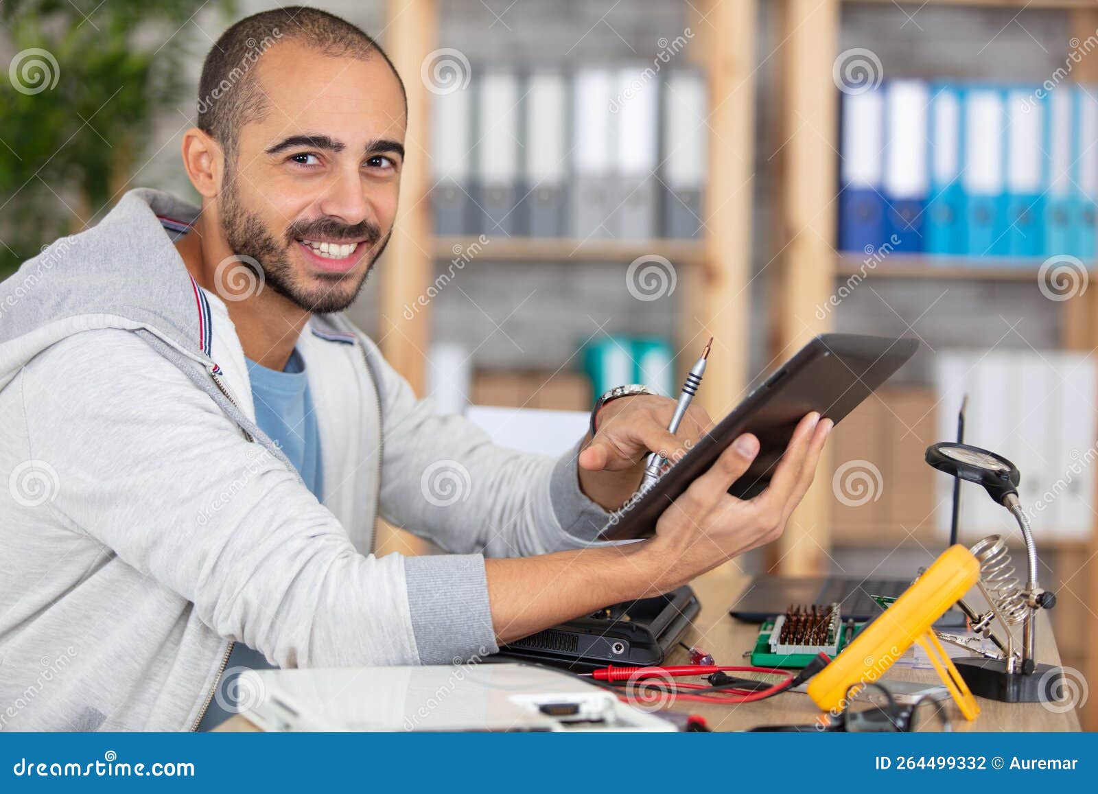 Man in Office Repairing Electrical Goods Uses Tablet Pc Stock Photo ...