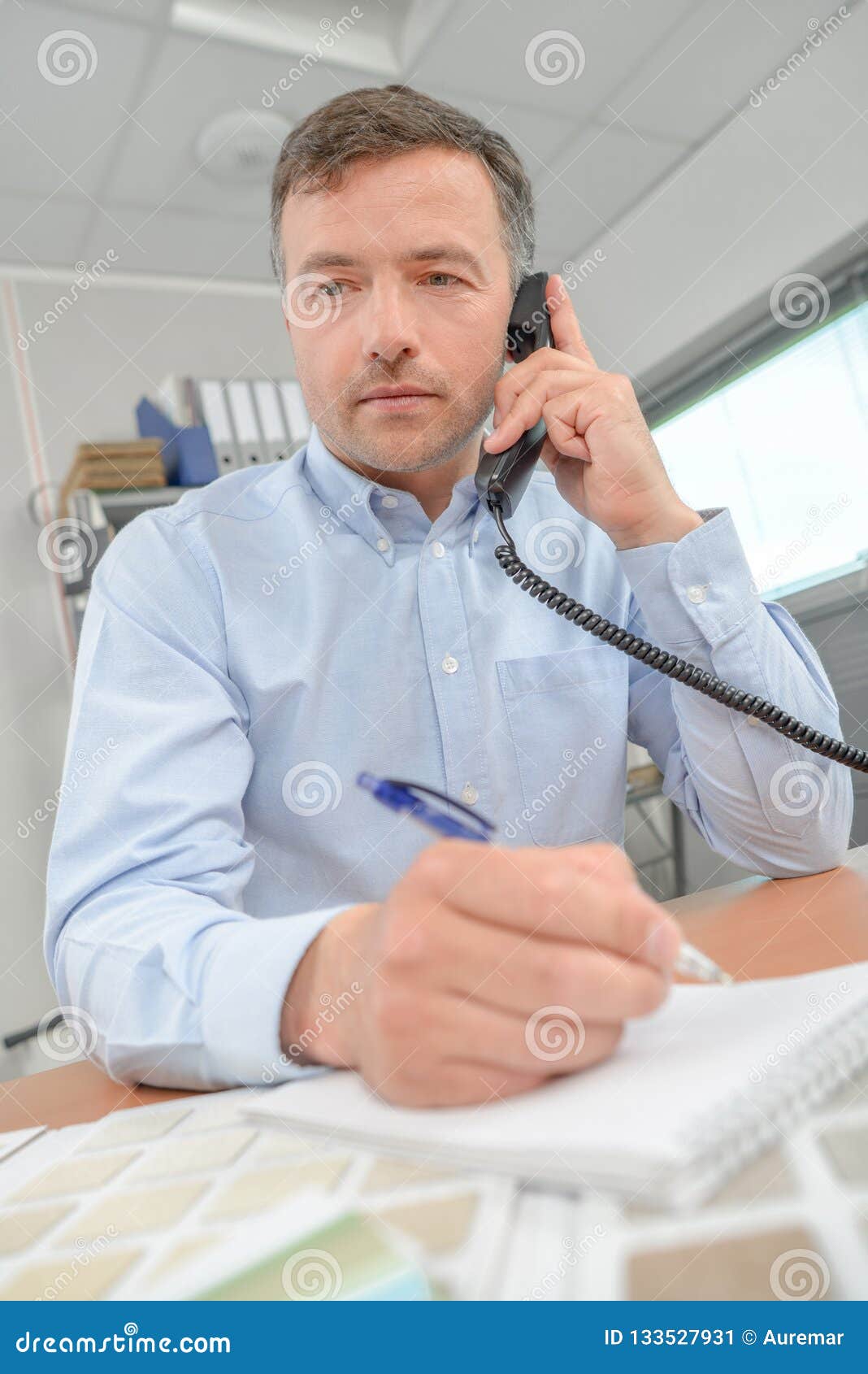 Man in office on telphone stock image. Image of professional - 133527931