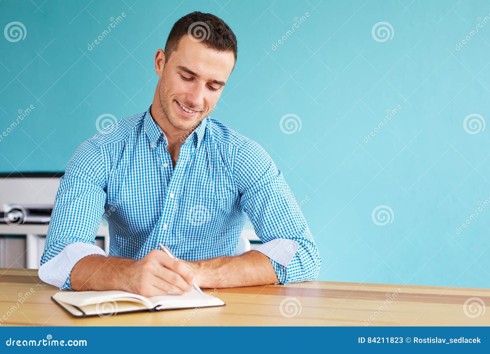 Man in the Office Writing Plan in Diary Stock Image - Image of smile ...