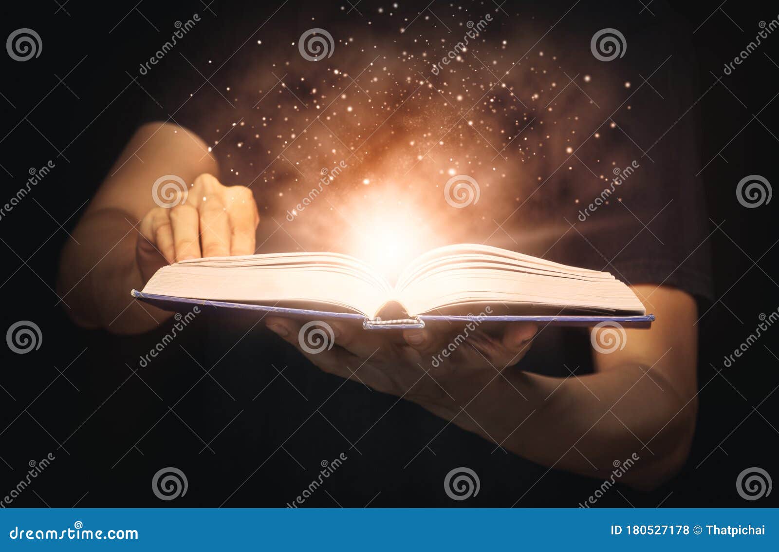 Man Open Magic Book with Growing Lights and Magic Powder Floating on ...
