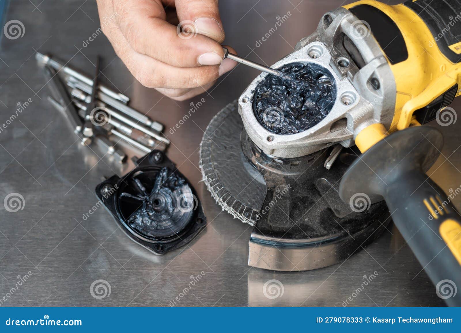 Man Open Up the Gear Box or Gear Housing of Old Angle Grinder and ...