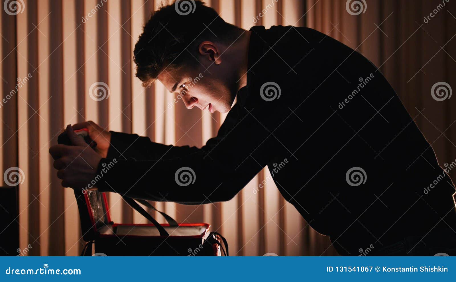 A Man Opening Case and Looking Inside Stock Image - Image of holding ...