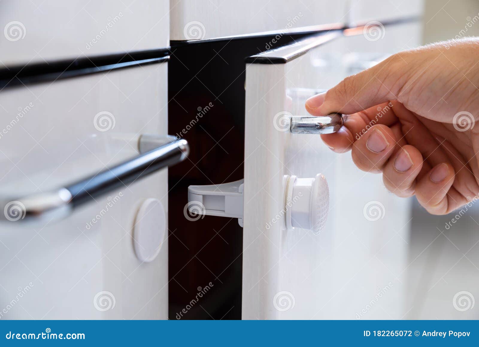 Man Opening Child Proof Kitchen Cabinets Stock Photo - Image of macro ...