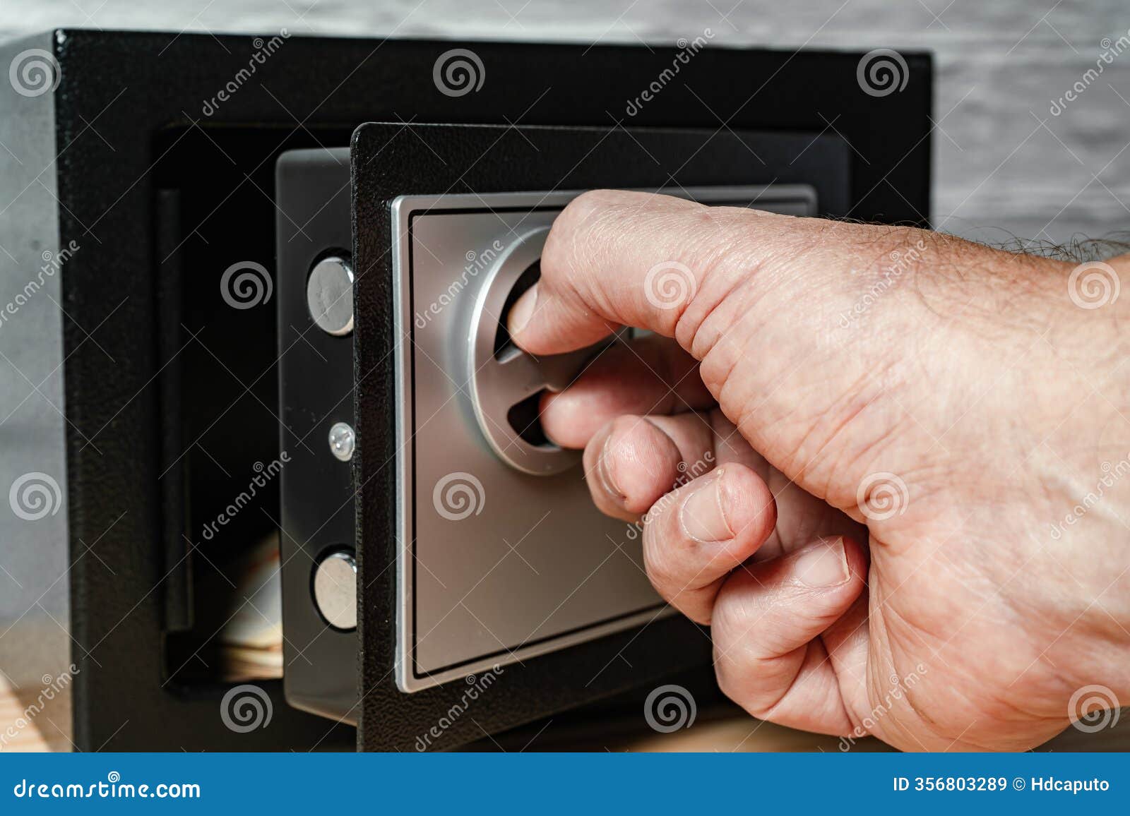 Man Opening the Door of a Home Safe by Turning the Security Lock Stock ...