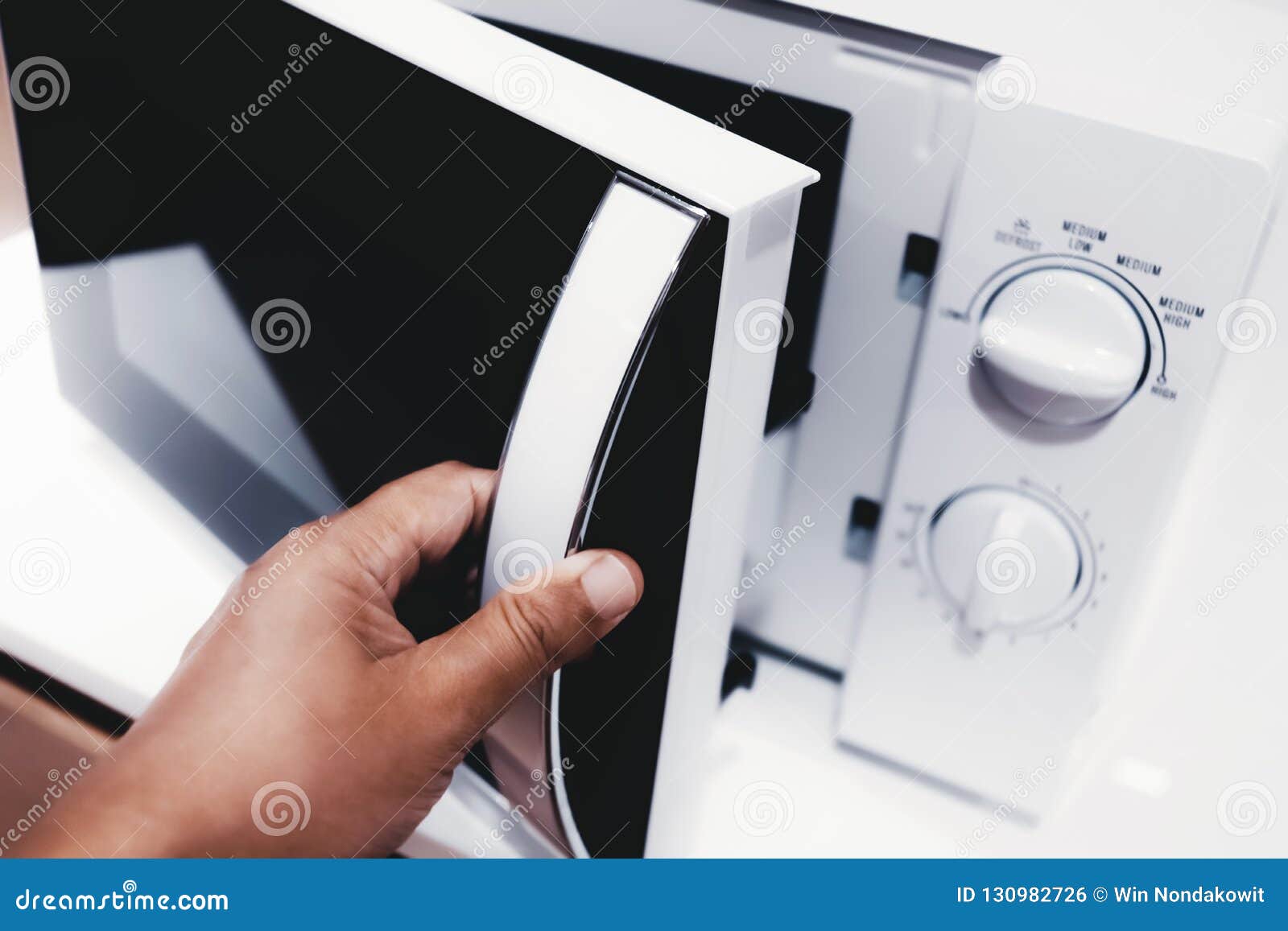 Man opening microwave oven stock photo. Image of kitchen - 130982726