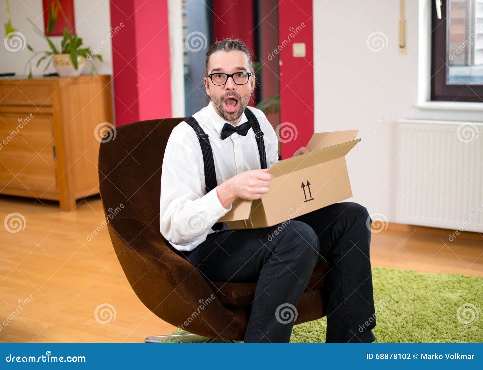 Man Opening a Package and is Amazed Stock Photo - Image of living ...