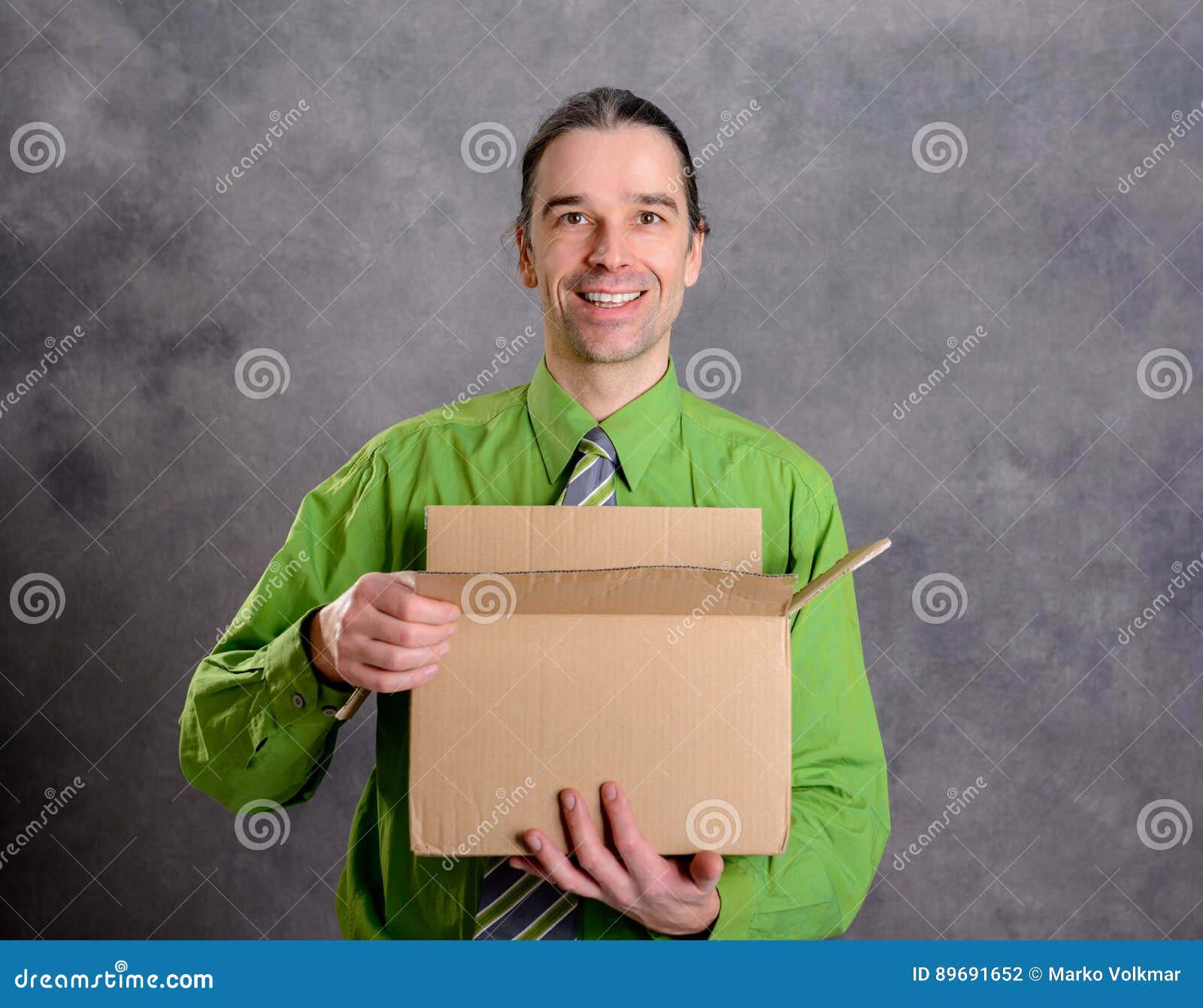 Man Opening a Package and Looking Surprised Stock Photo - Image of ...